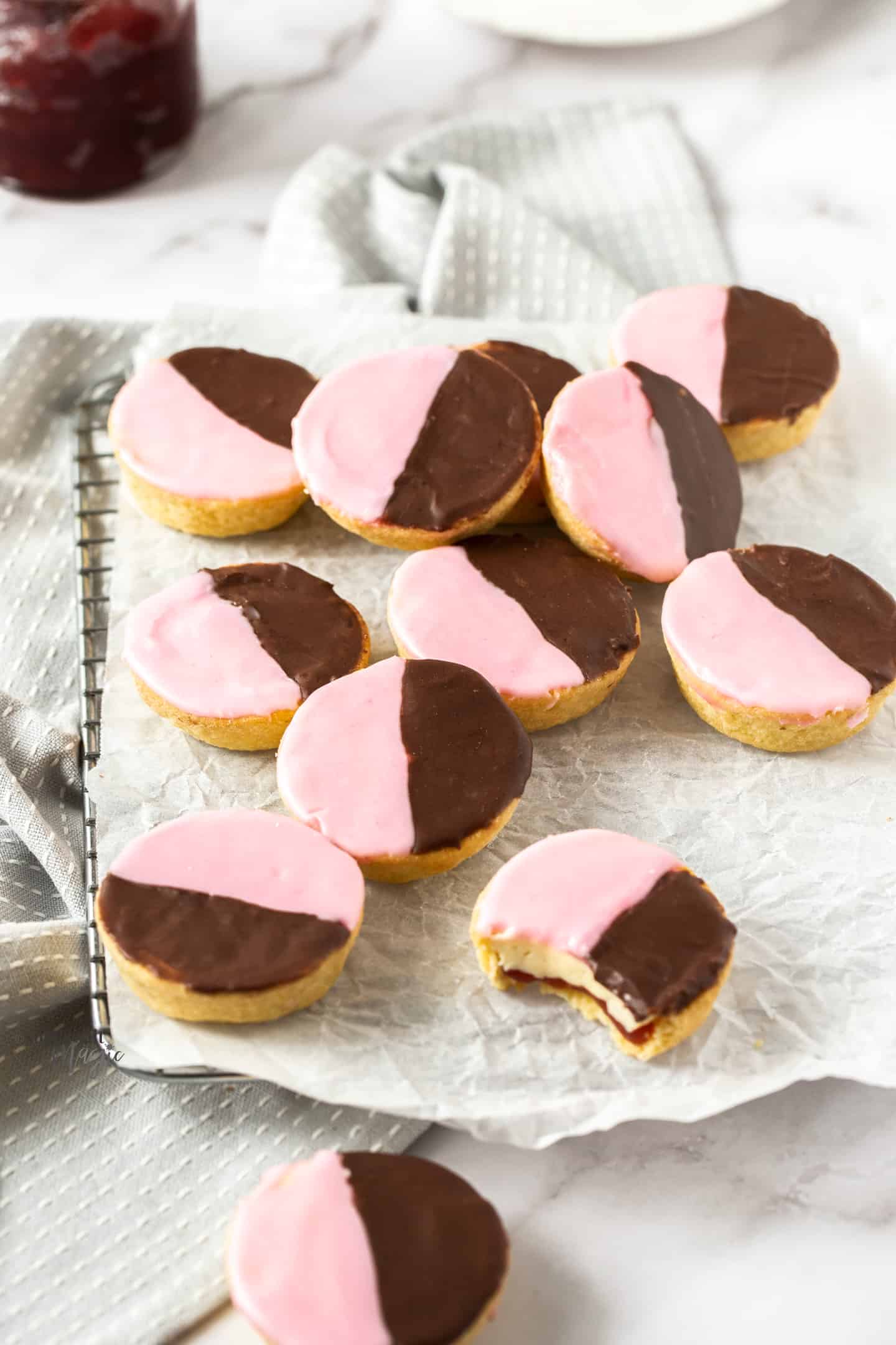 A batch of neenish tarts on a sheet of baking paper over a wire rack.